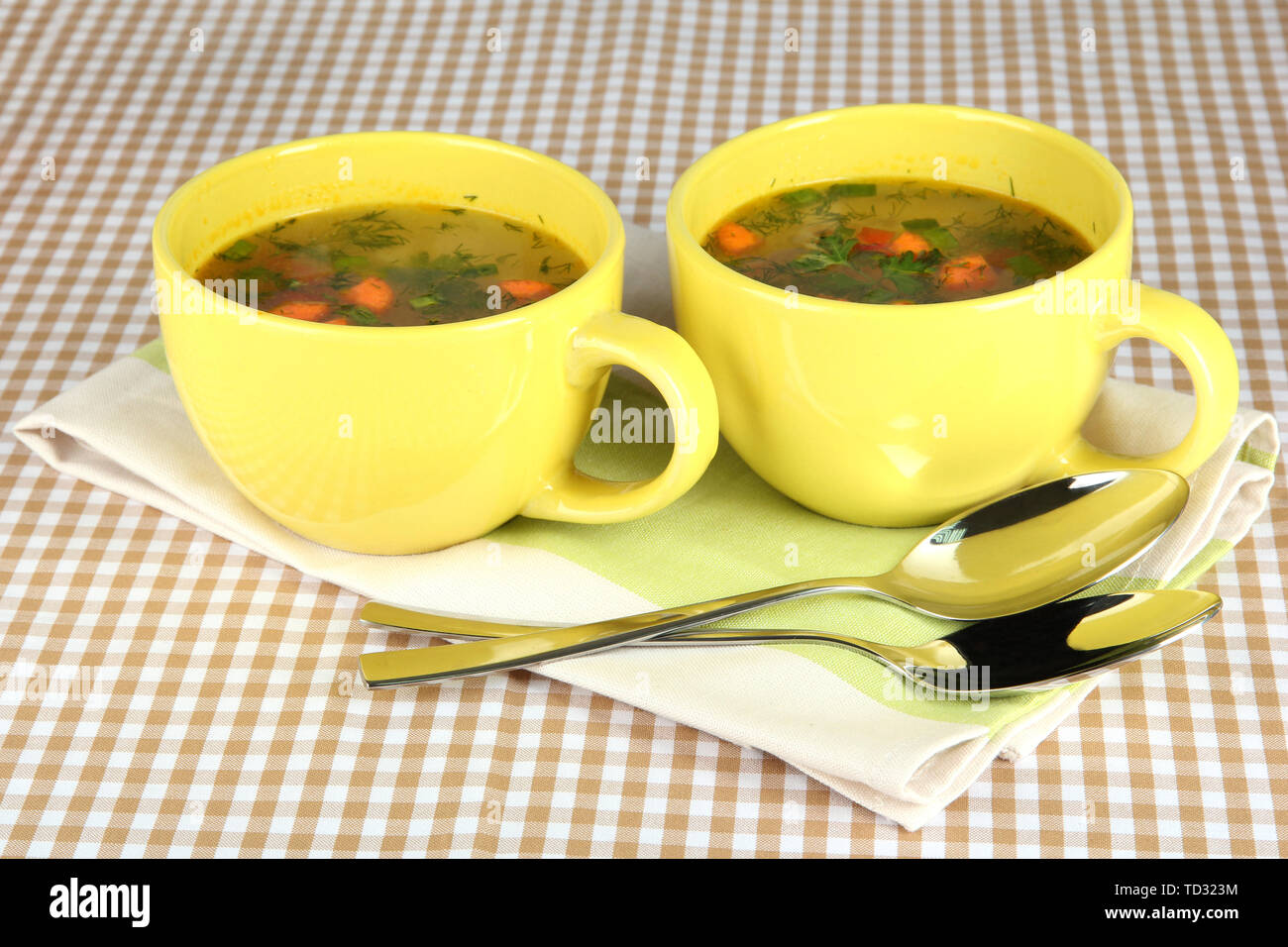 Fragrant soup in cups on table in kitchen Stock Photo - Alamy