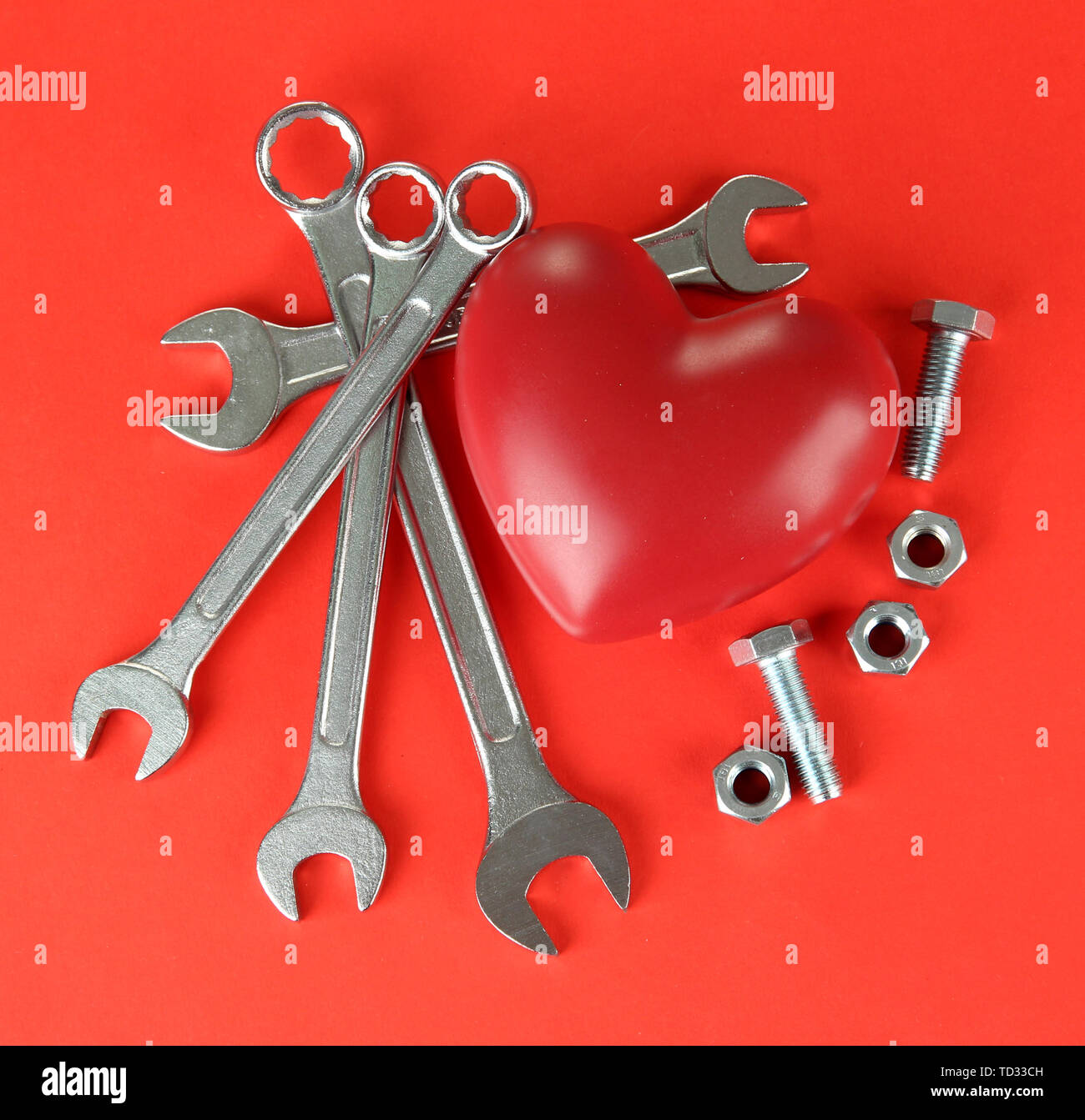 Heart and tools. Concept: Renovation of heart. On color background ...