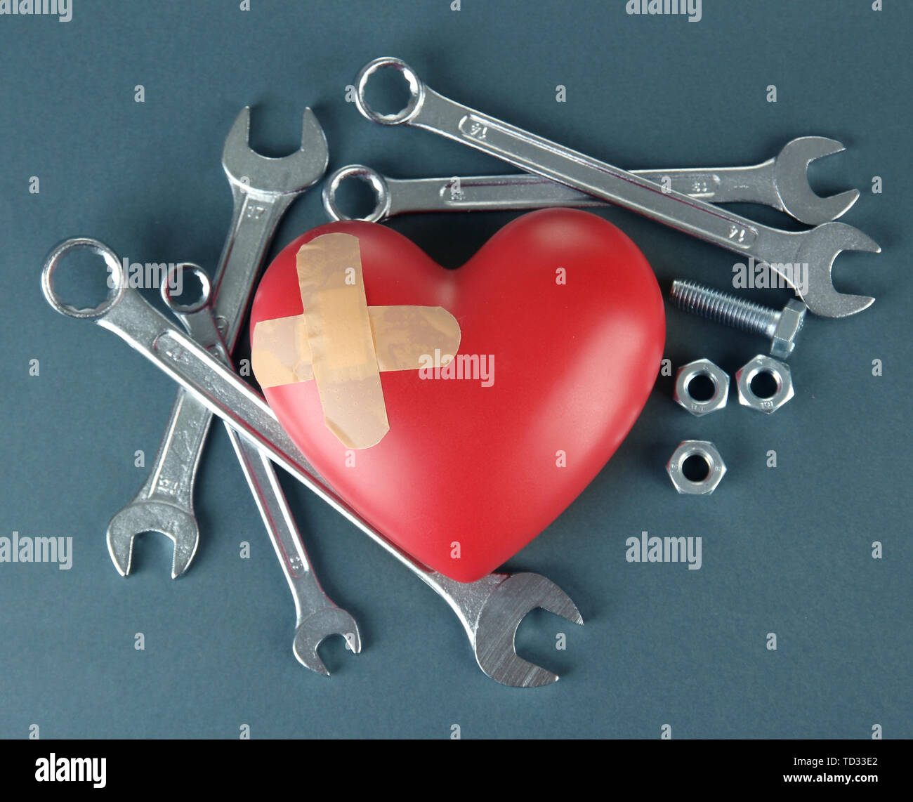 Heart and tools. Concept: Renovation of heart. On color background ...