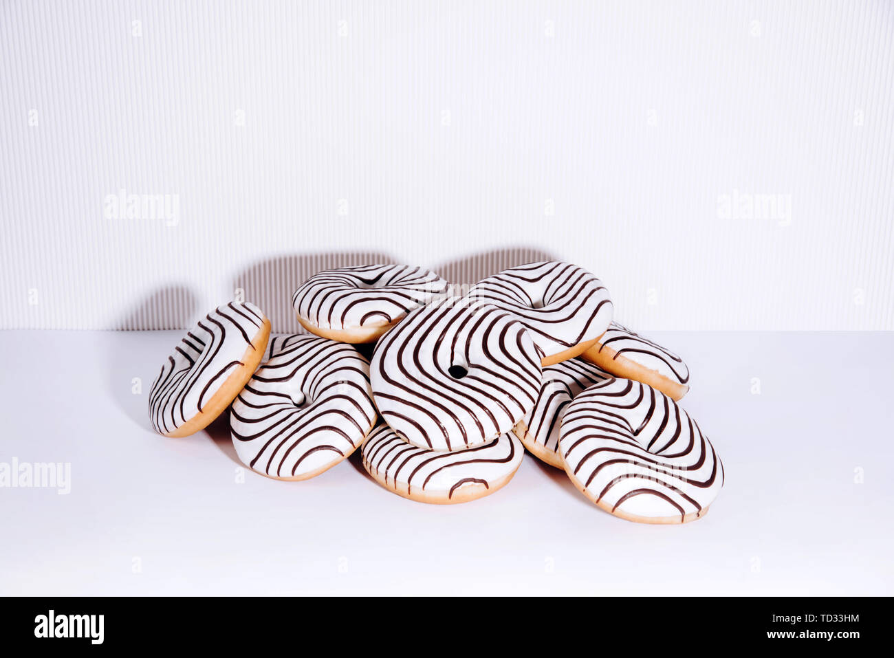 Striped donuts on a white background. Stylish minimal concept Stock ...