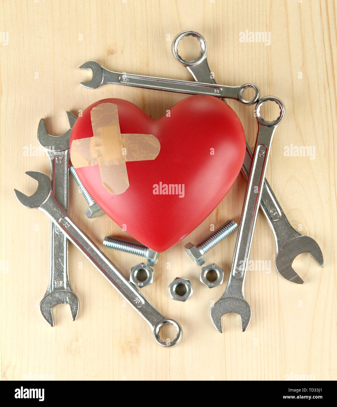 Heart and tools. Concept: Renovation of heart. On wooden background ...