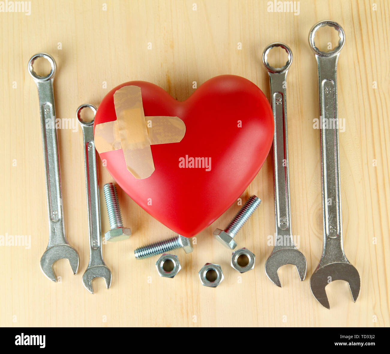 Heart and tools. Concept: Renovation of heart. On wooden background ...