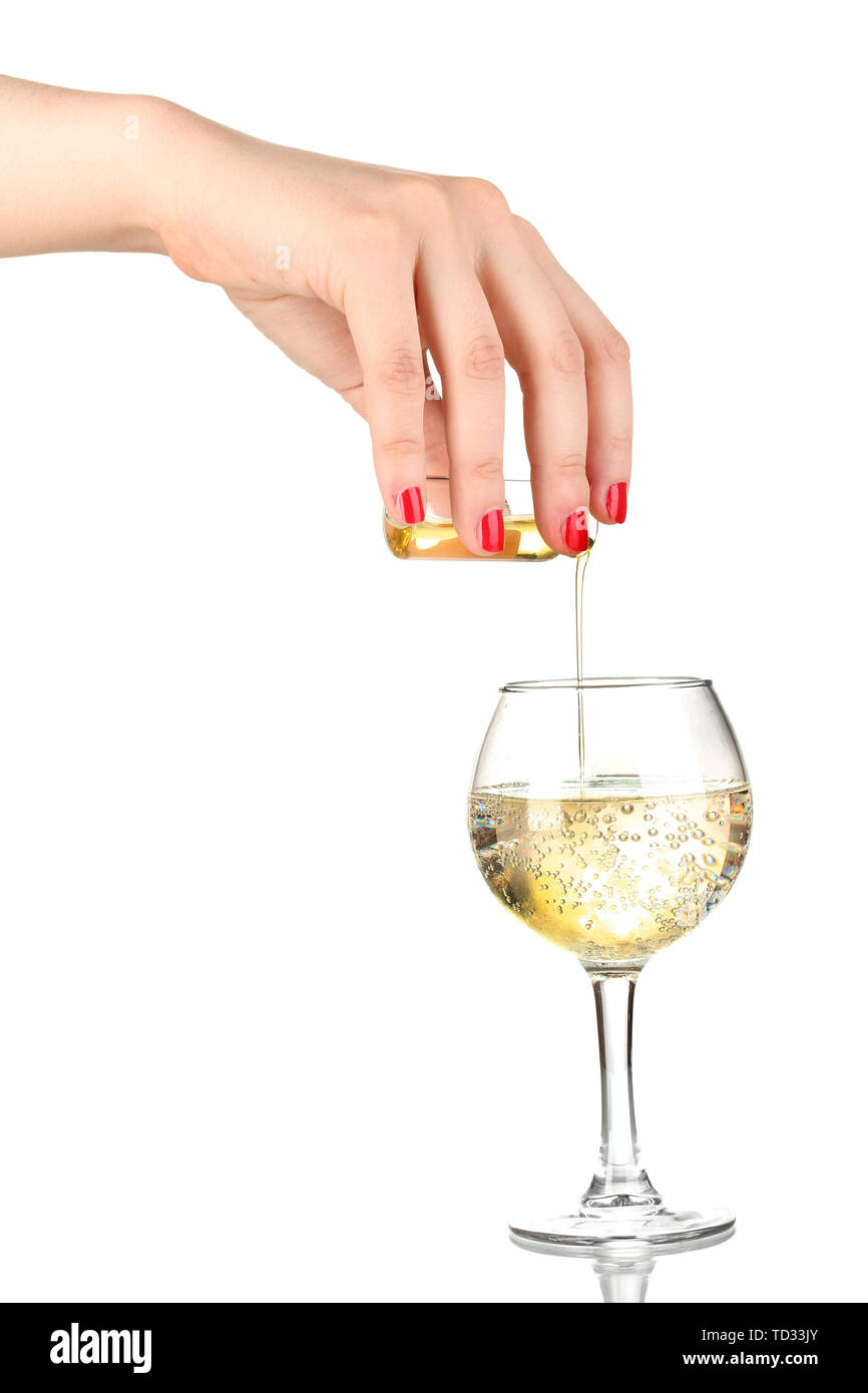 Pour something into glass with drink isolated on white Stock Photo - Alamy