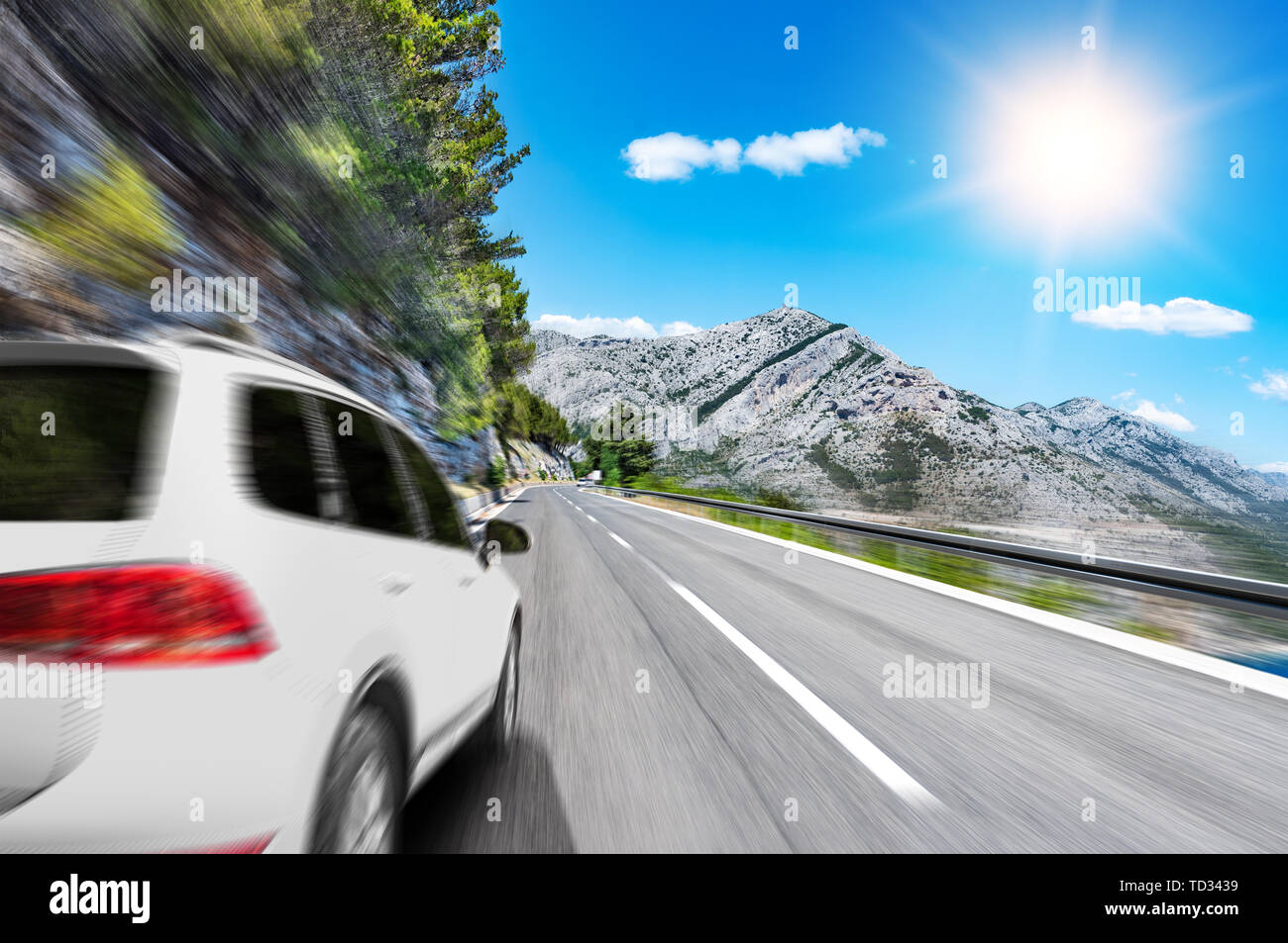 White car rushing along a high-speed highway Stock Photo - Alamy