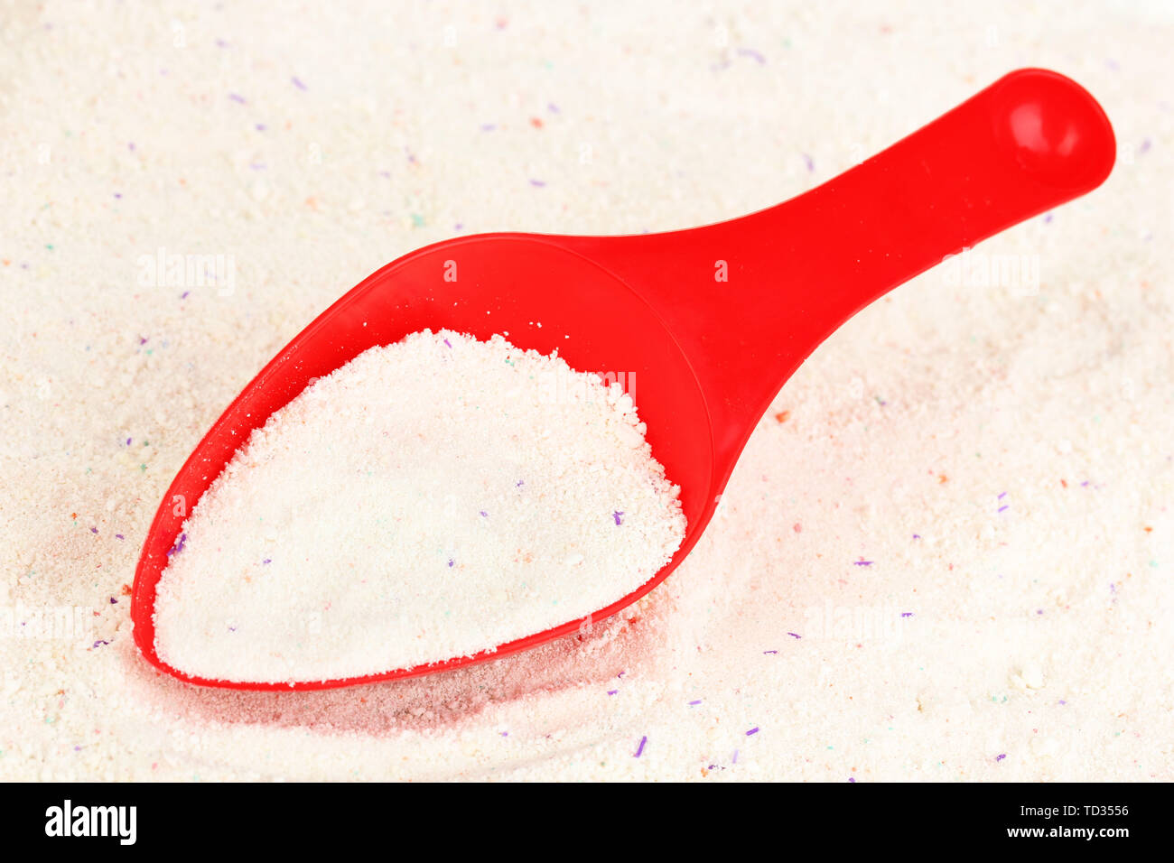 Washing powder in measuring cup on powder background Stock Photo - Alamy
