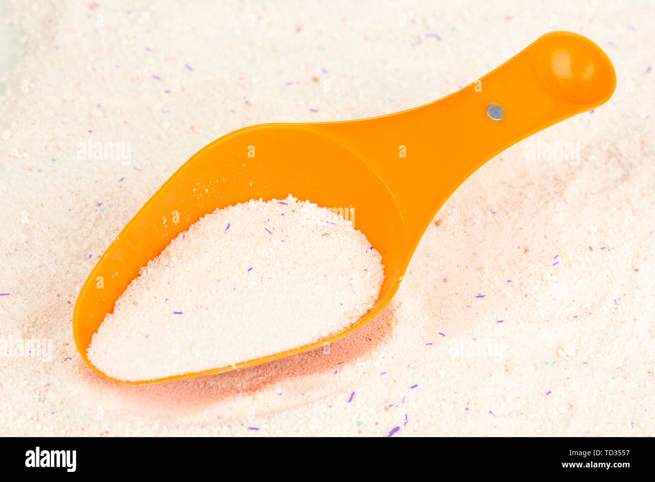Washing powder in measuring cup on powder background Stock Photo - Alamy