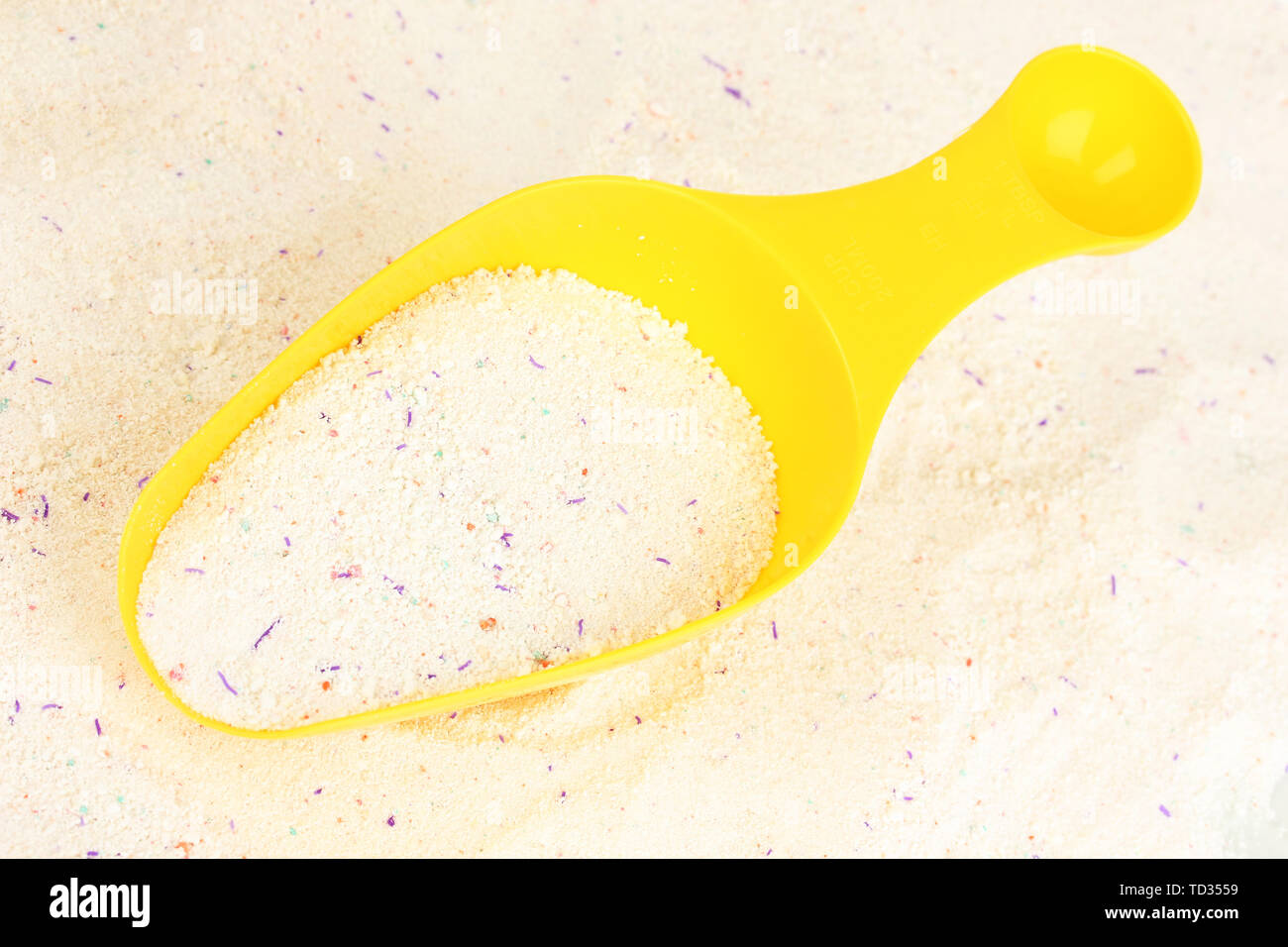 Washing powder in measuring cup on powder background Stock Photo - Alamy
