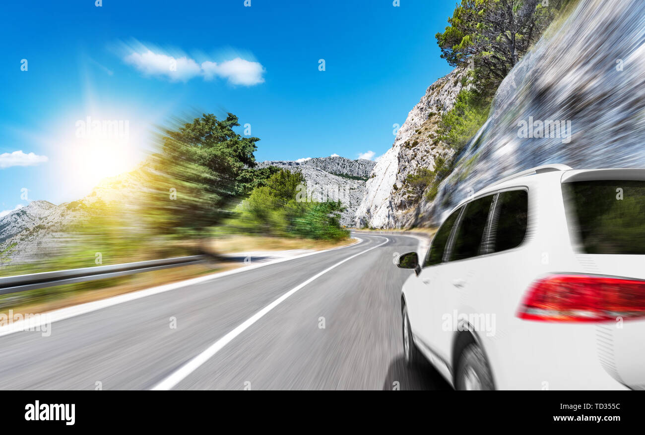 White car rushing along a high-speed highway Stock Photo - Alamy
