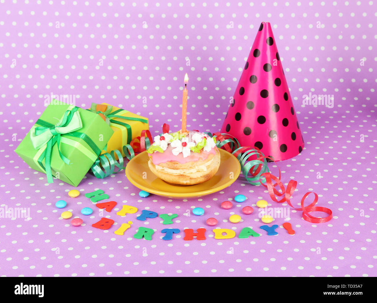 Colorful birthday cake with candle and gifts on pink background Stock ...