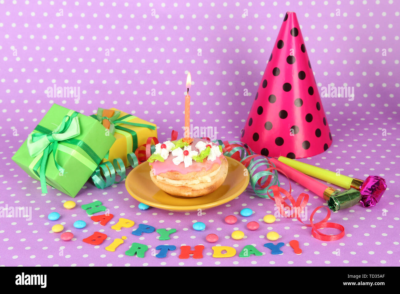 Colorful birthday cake with candle and gifts on pink background Stock ...