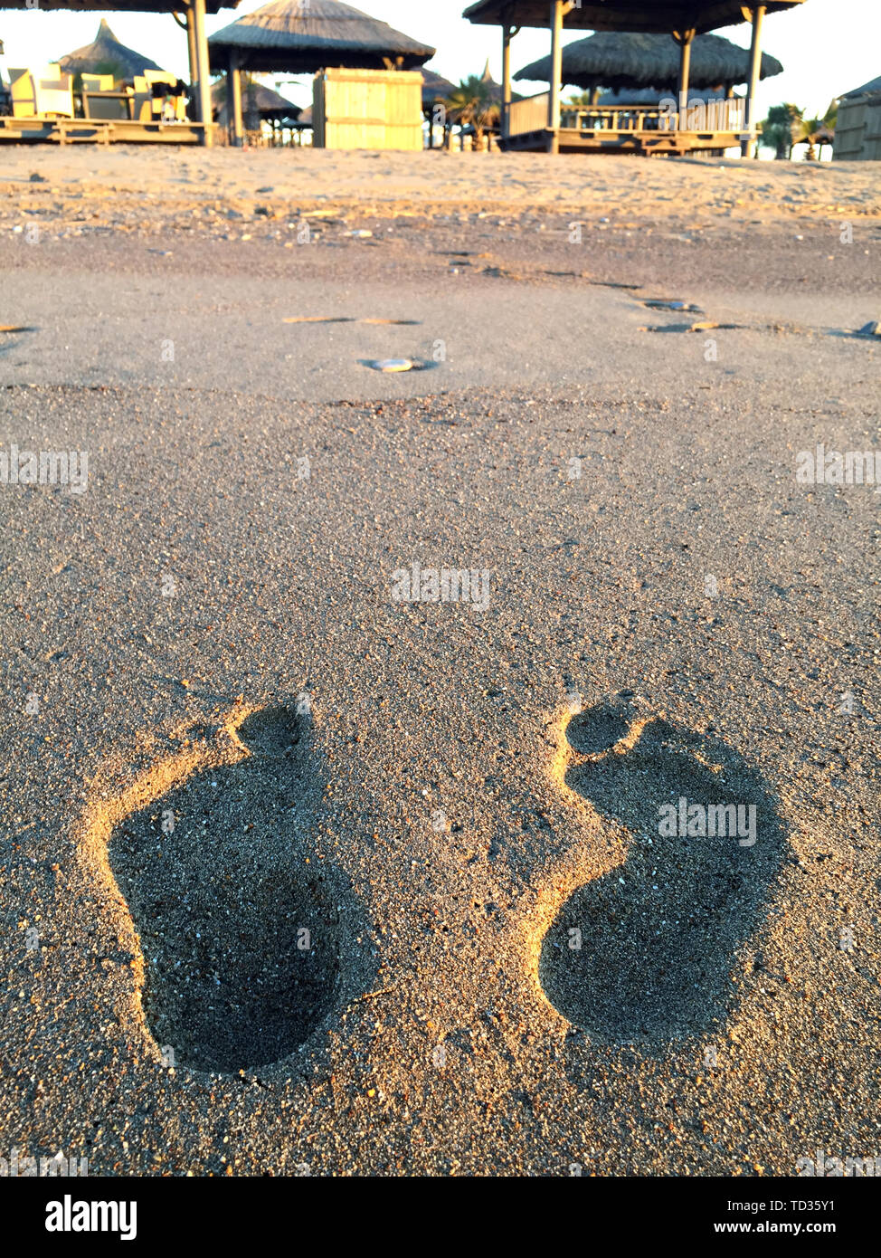 Footprints in the sand at sunset. Beautiful sandy tropical beach with ...