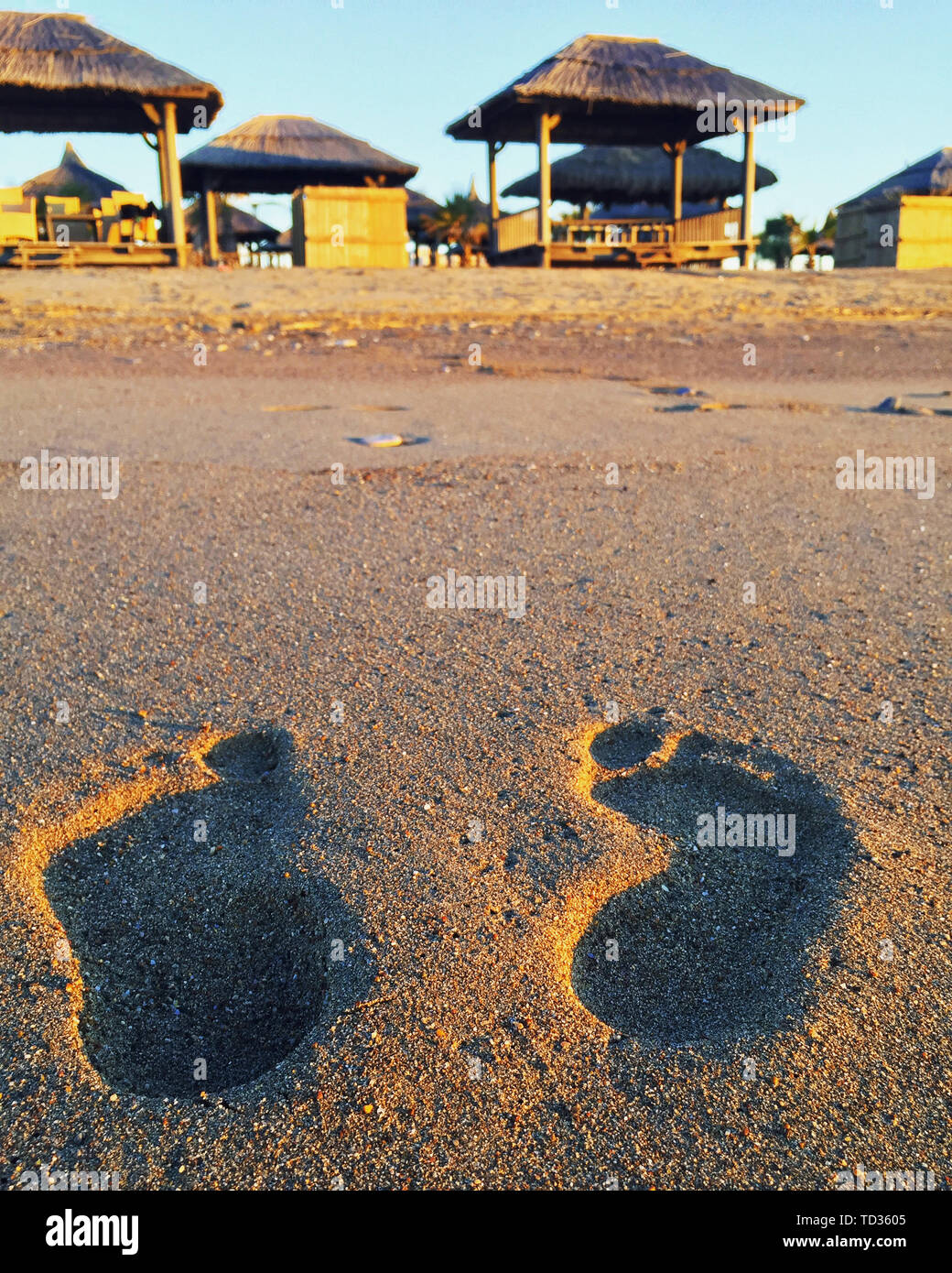Footprints in the sand at sunset. Beautiful sandy tropical beach with ...