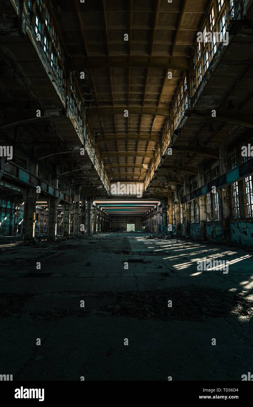 Indoors of an old large abandoned facility Stock Photo - Alamy
