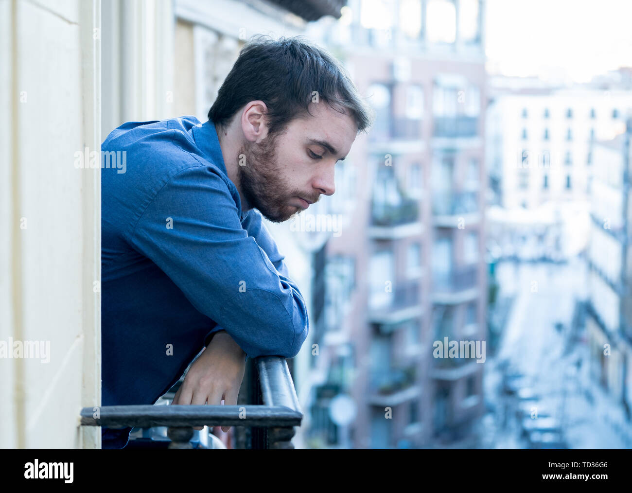 Lonely sad man staring outside house balcony feeling depressed distress ...