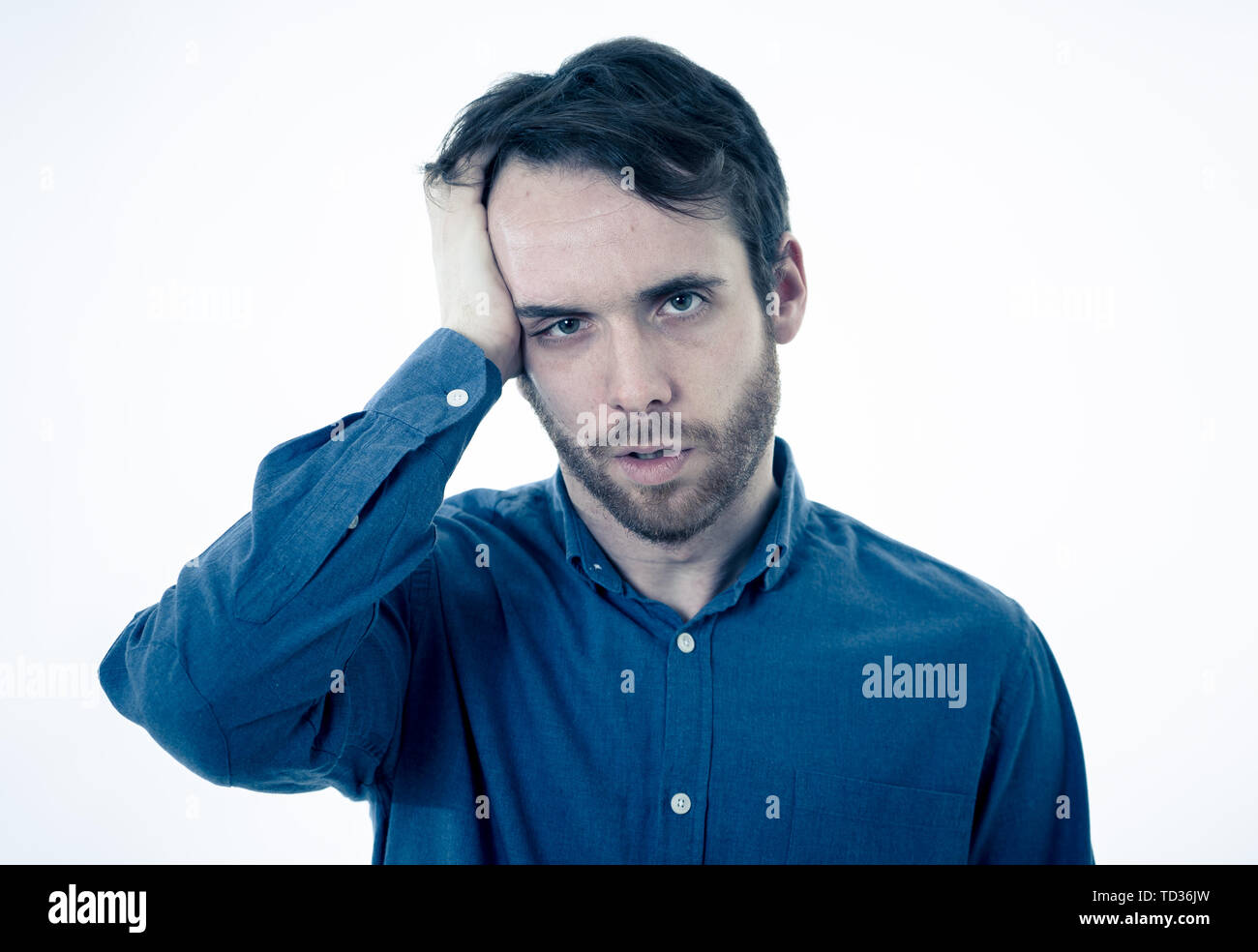 Portrait of a young bearded man looking worried and thoughtful ...