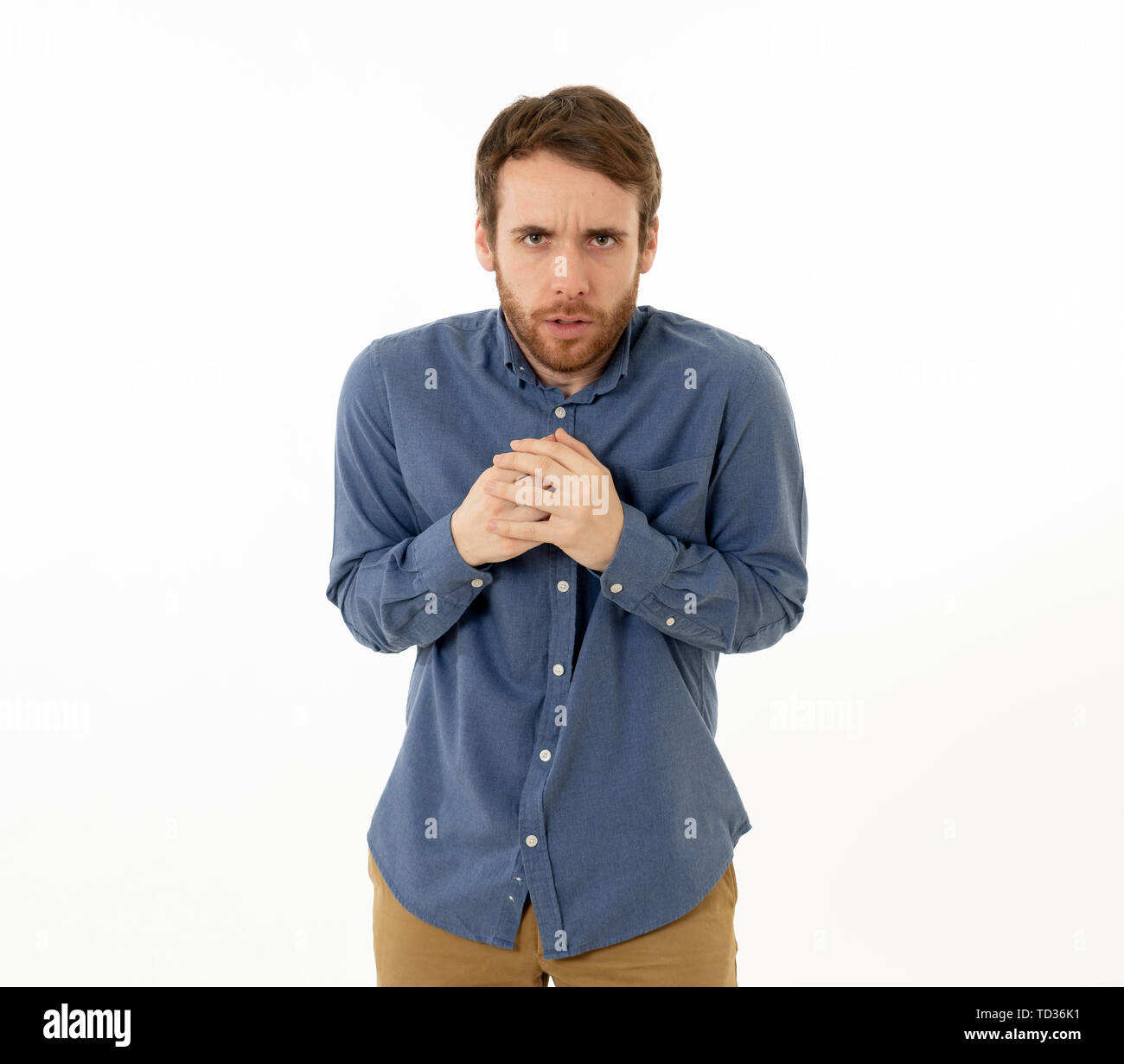 Portrait of young man in shock with scared face paralysed with fear and ...