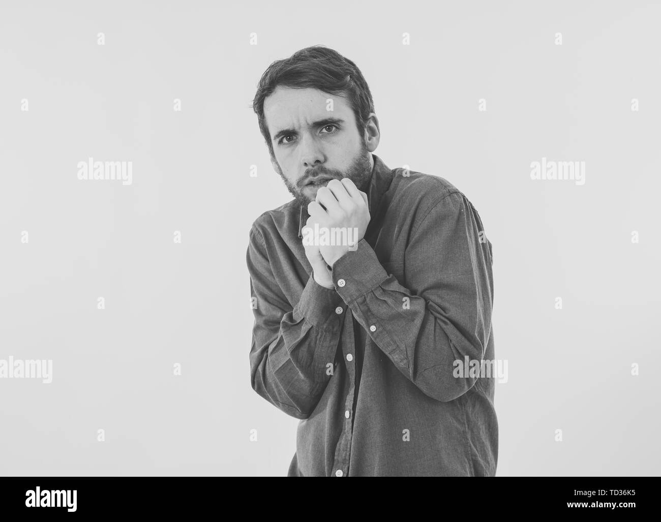 Portrait of young man in shock with scared face paralysed with fear and ...