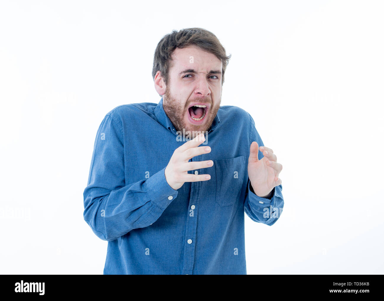 Portrait of young man in shock with scared face paralysed with fear and ...