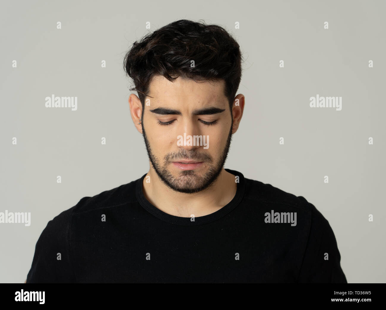 Young sad man suffering from depression looking serious and concerned ...