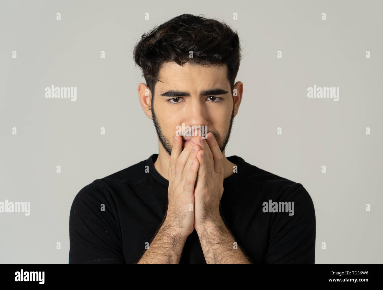 Young sad man suffering from depression looking serious and concerned ...