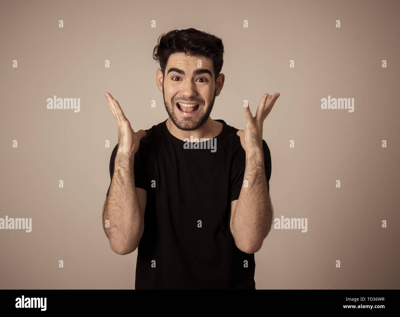Portrait of a handsome latin young man surprised and shocked hearing ...
