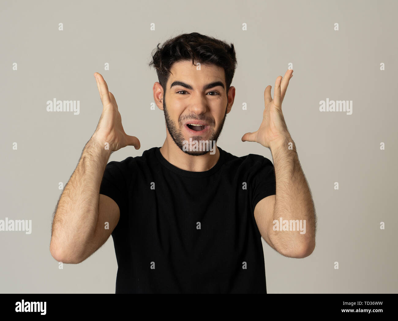 Portrait of a handsome latin young man surprised and shocked hearing ...