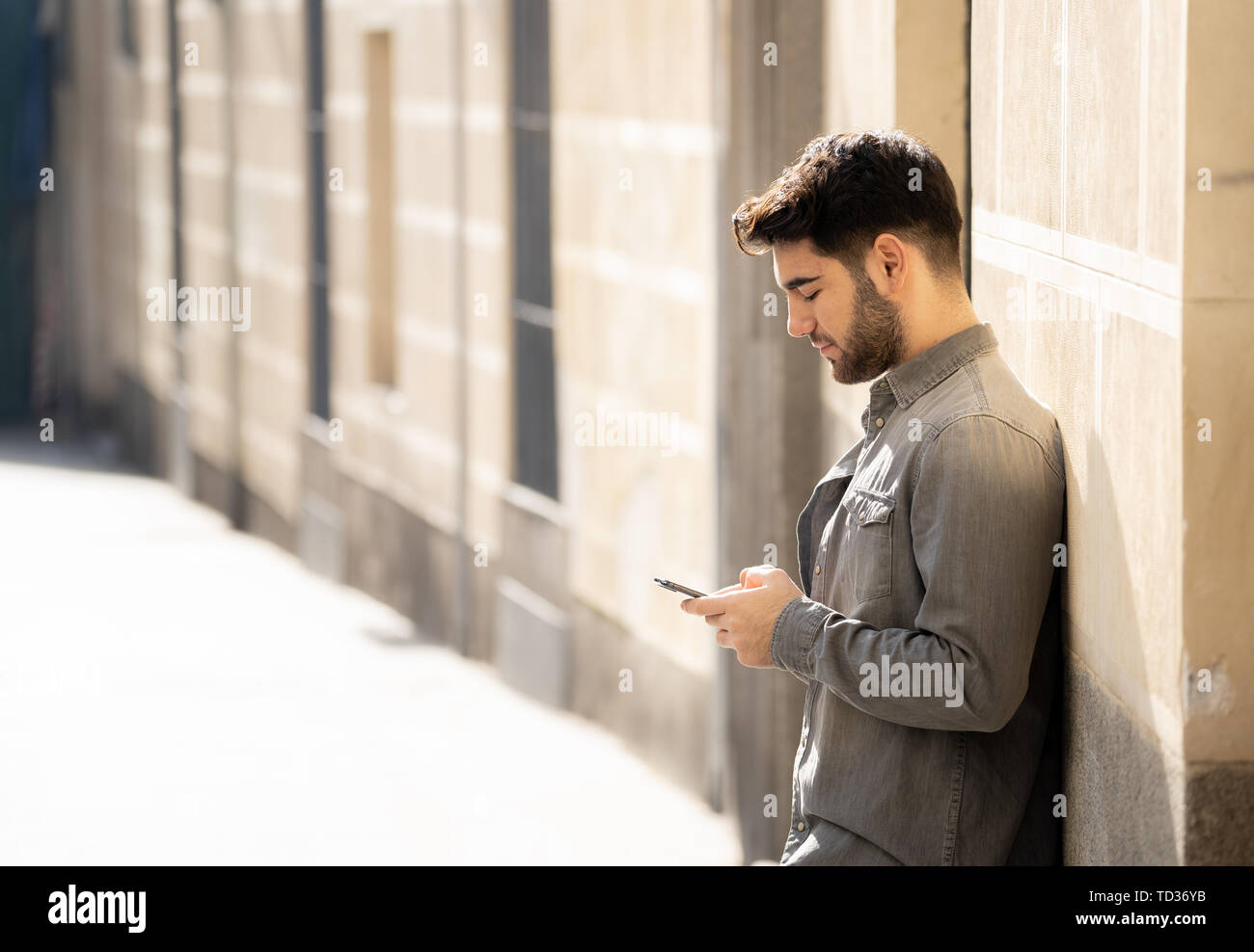 Fashion college man in his twenties happy checking blog or chatting on ...
