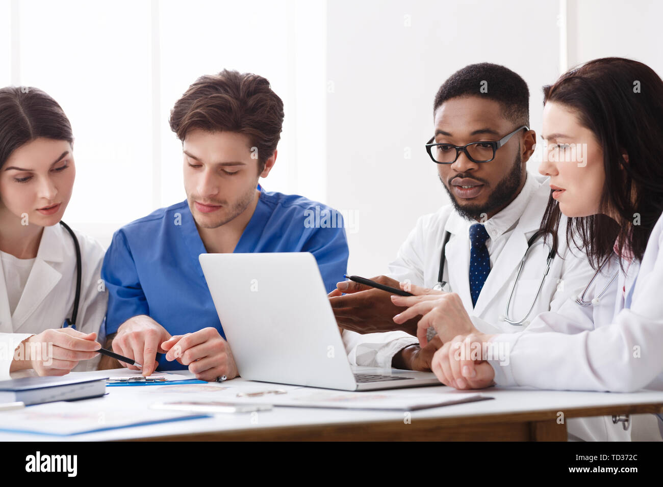 Medical Team Meeting In Hospital And Discussing Treatment Questions ...