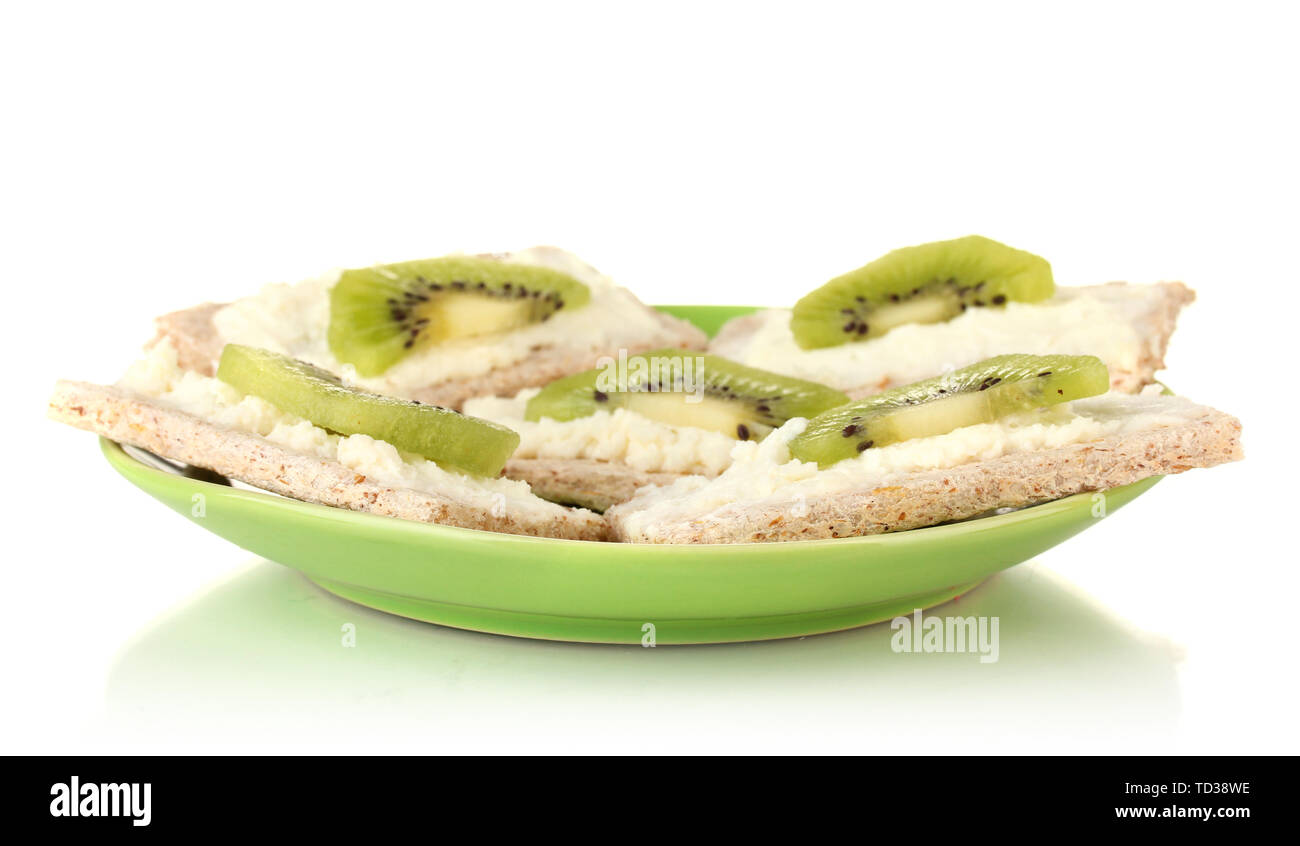 Canapes with cheese and kiwi, on color plate, isolated on white Stock ...