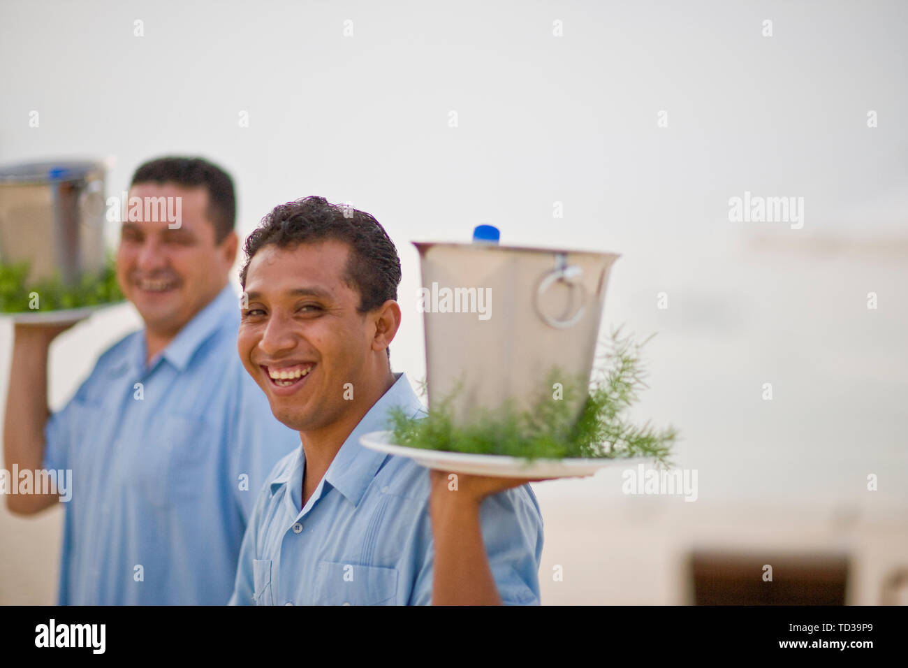 Beach resort waiters holding drinks in ice buckets Stock Photo - Alamy