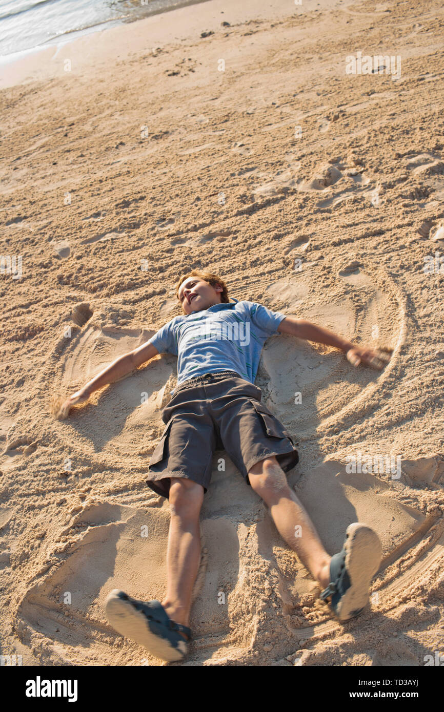 Happy Boy Lying In Sand High Resolution Stock Photography and Images ...