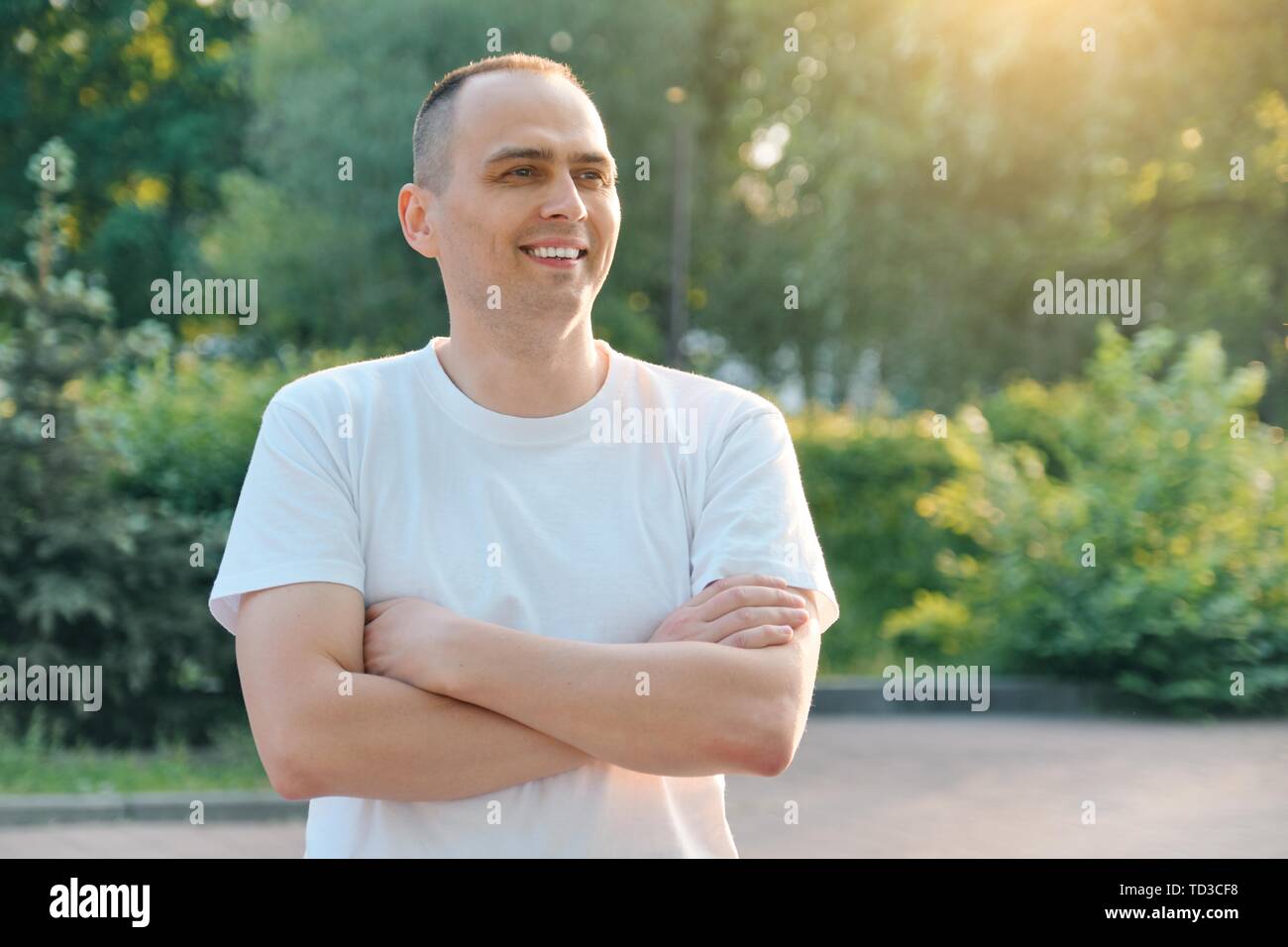 Outdoor portrait of confident smiling sporty man of 40 years. Positive ...