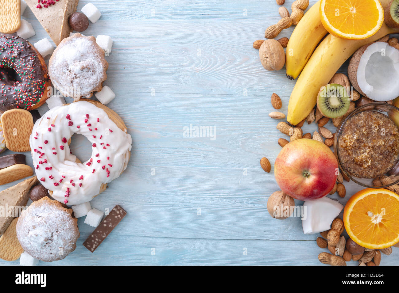 Unhealthy and healthy sweets on blue wooden background. Organic and ...