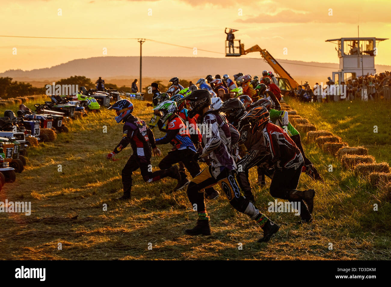 The mowers start Le--Mans style, fighting for position at the the first ...