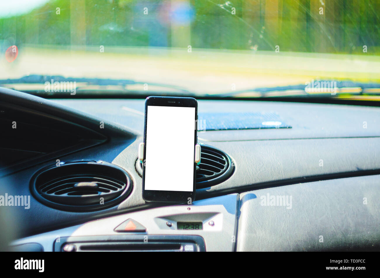 Smartphone on the front of the car as a navigator. Cut out the white ...