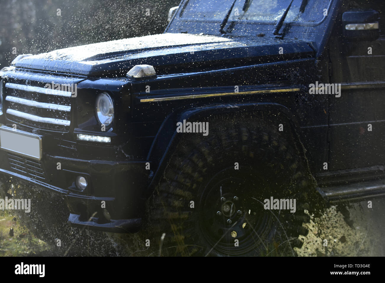 Off road vehicle or SUV overcomes obstacles. Car racing in autumn ...