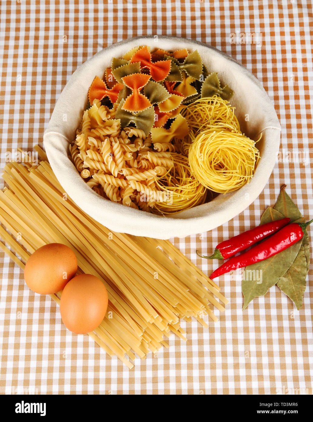 Different types of pasta on checkered background Stock Photo - Alamy