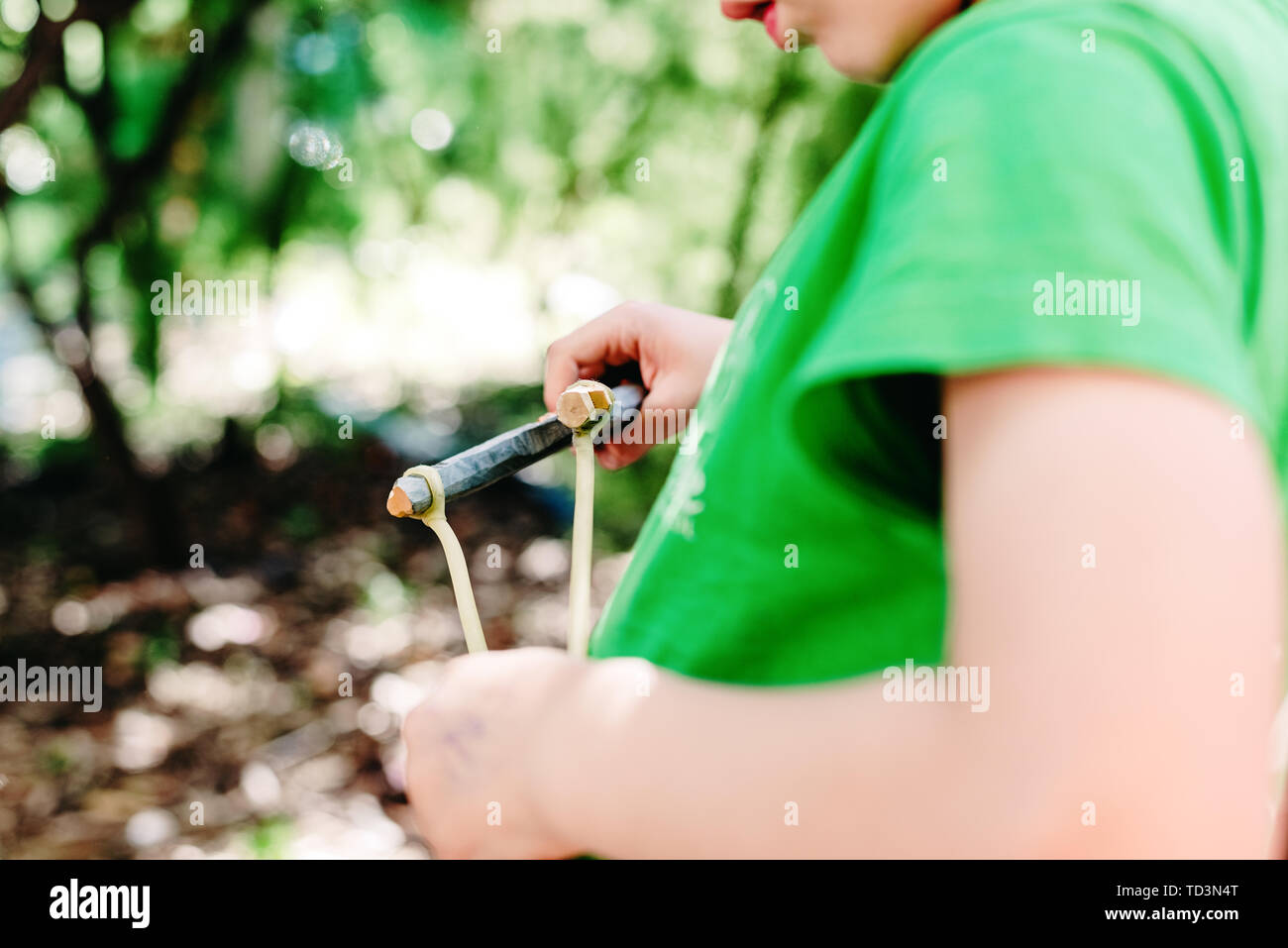 Child playing with his slingshot in a park having fun in freedom Stock ...
