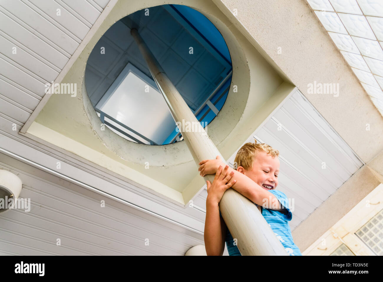 Happy child sliding down the pole of a fire station Stock Photo - Alamy