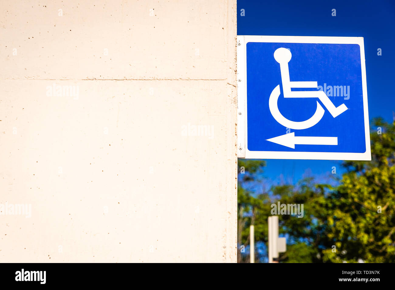 Blue square sign to indicate the way to disabled people in a wheelchair ...
