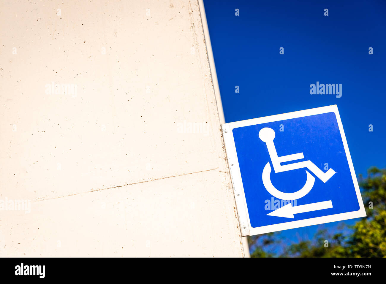 Blue square sign to indicate the way to disabled people in a wheelchair ...