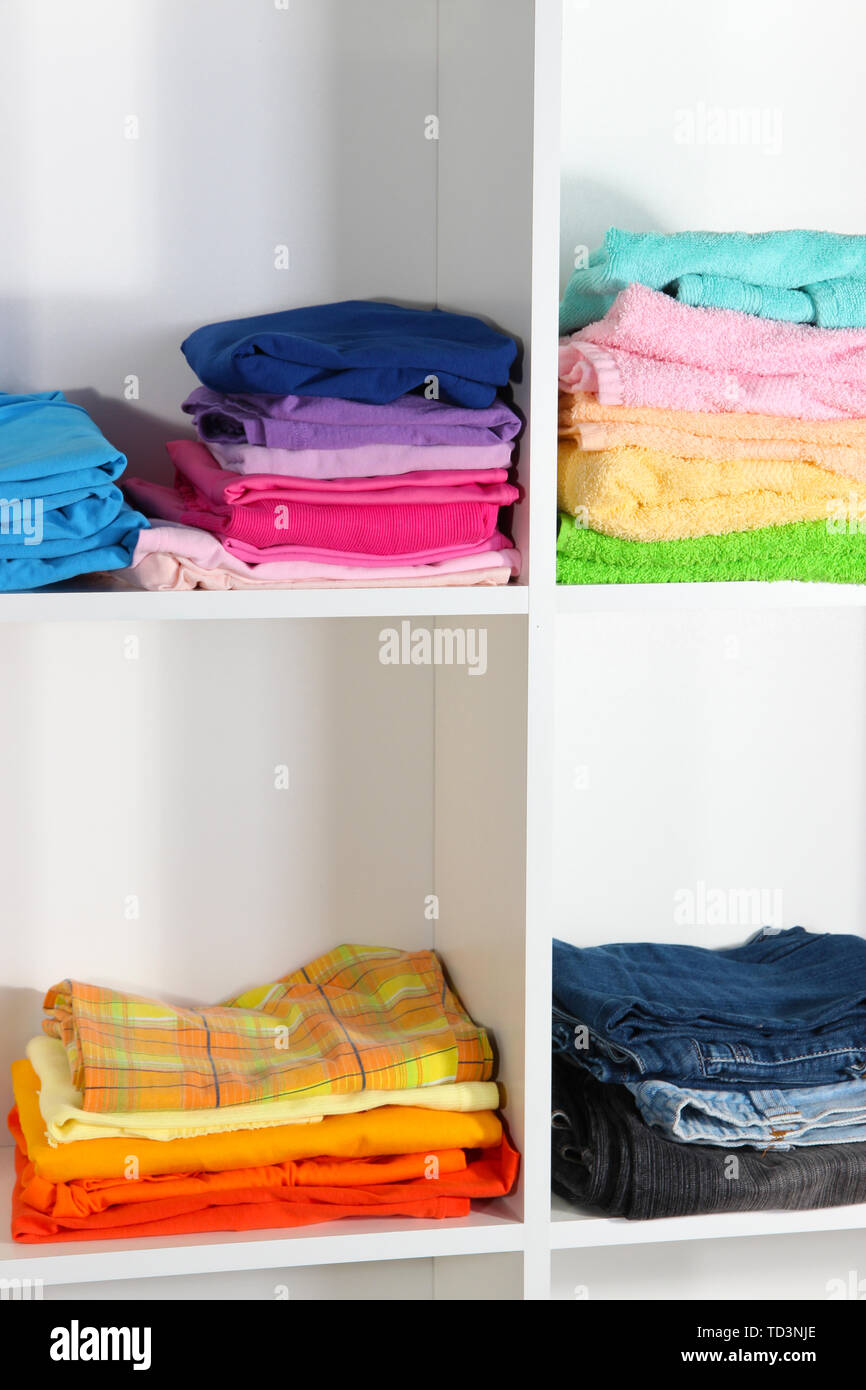 Clothes neatly folded on shelves Stock Photo - Alamy