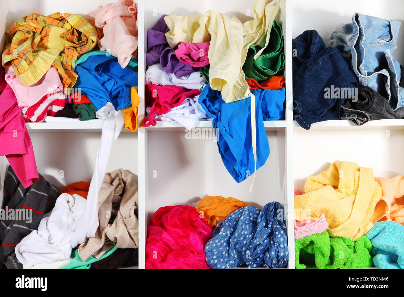 Clothing scattered on shelves Stock Photo - Alamy