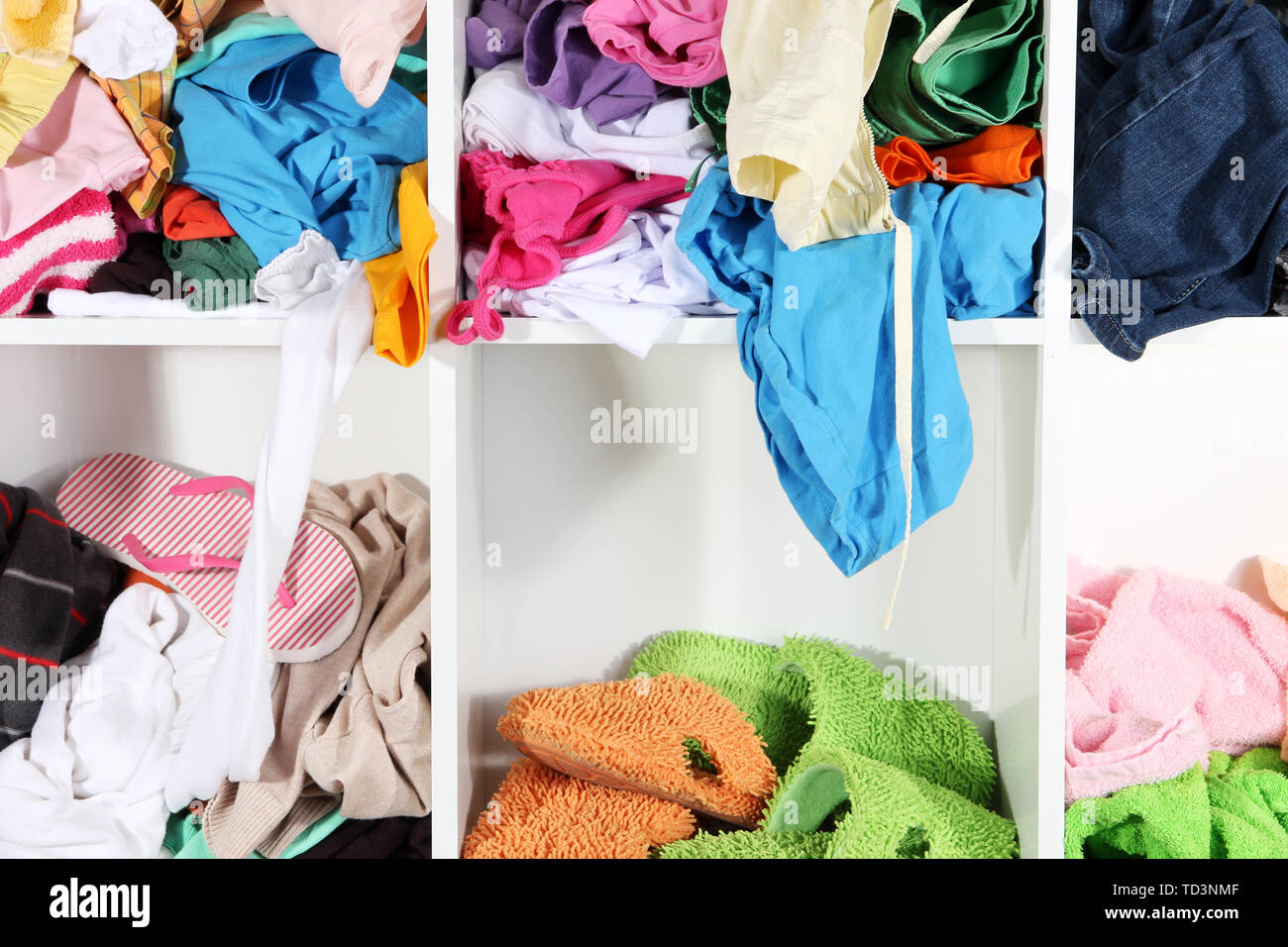 Clothing scattered on shelves Stock Photo - Alamy