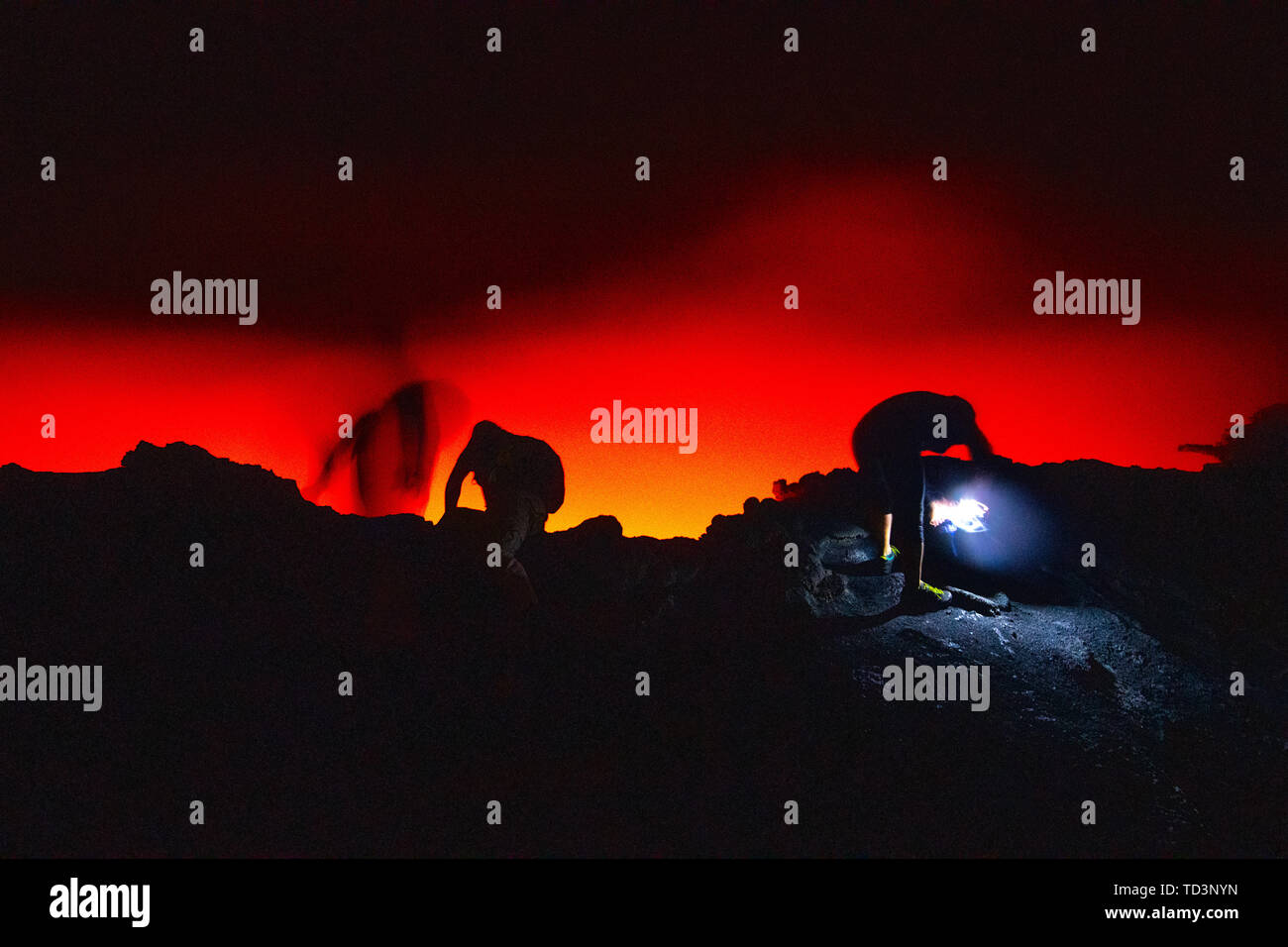 The night sky glows bright red as tourists explore the Erta Ale Volcano ...