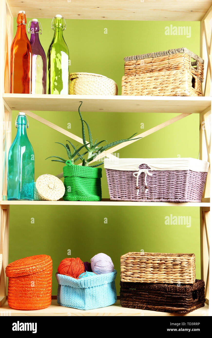 Beautiful white shelves with different home related objects, on color ...