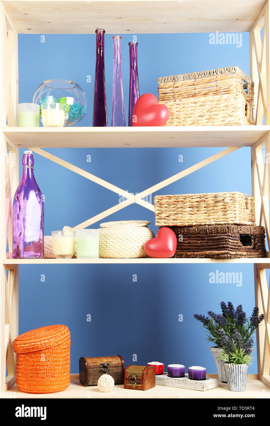 Beautiful white shelves with different home related objects, on color ...