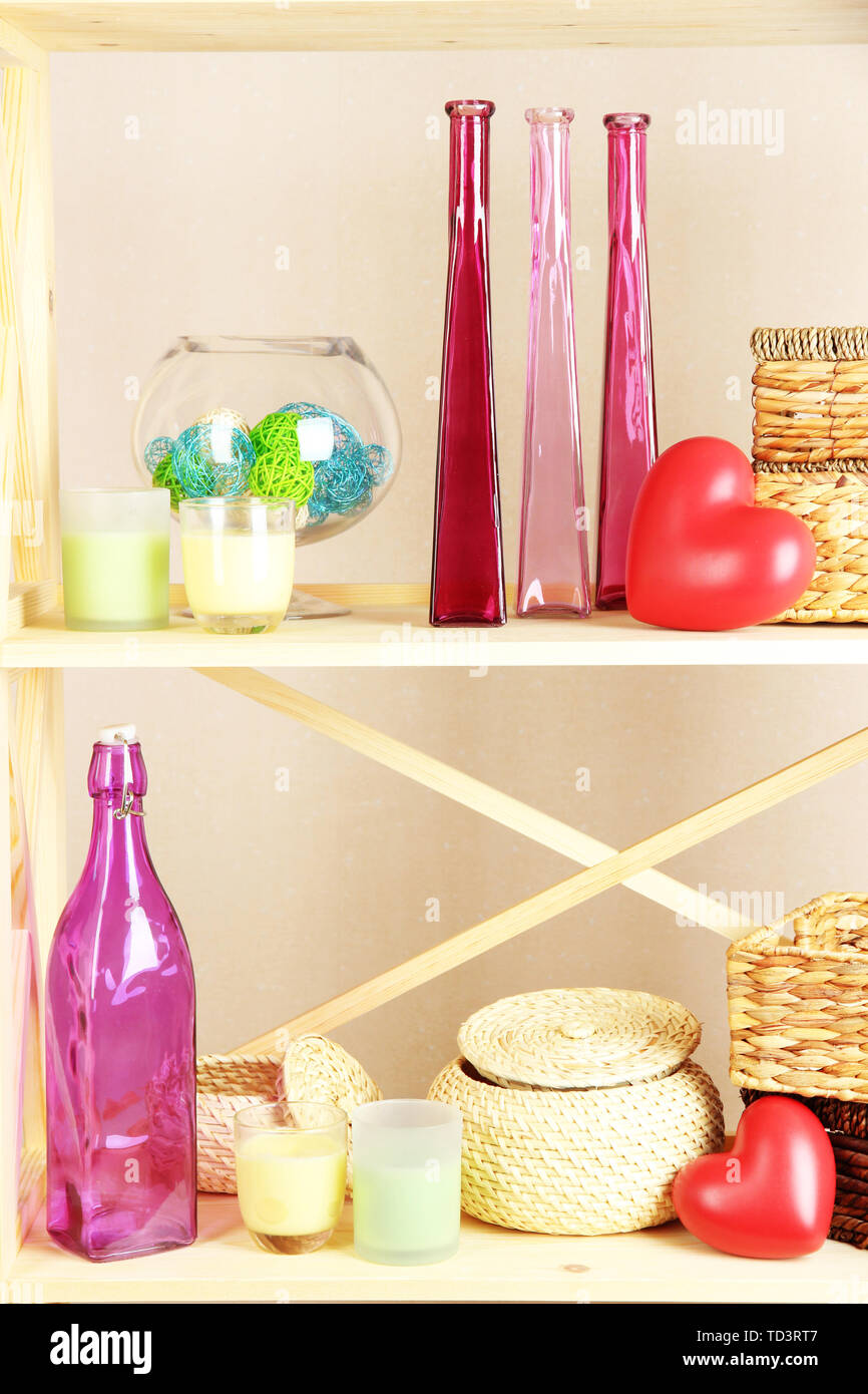Beautiful white shelves with different home related objects, on color ...