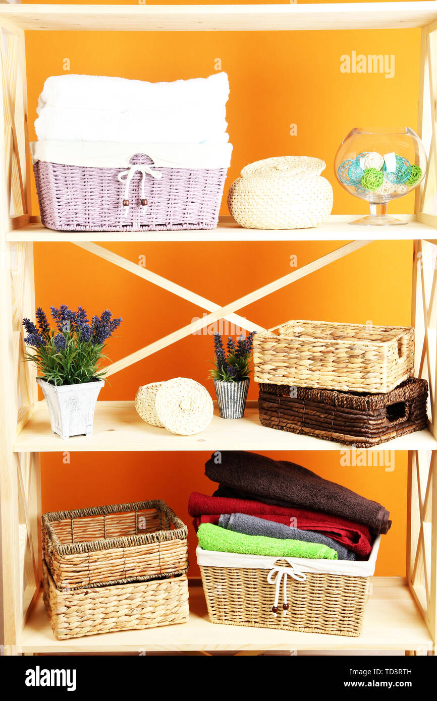Beautiful white shelves with different home related objects, on color ...