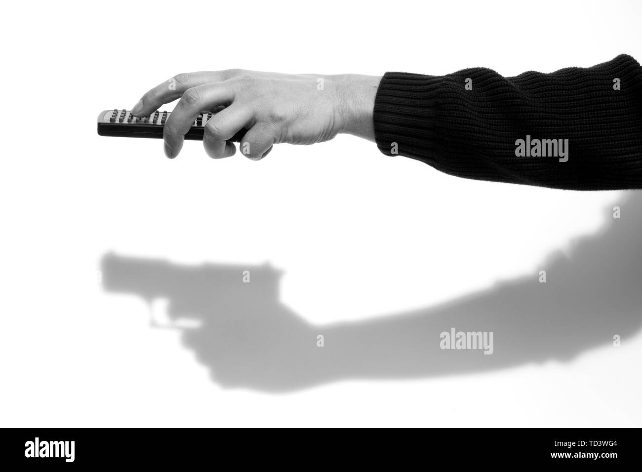 hand using remote control, casting the shadow of a hand with a gun ...